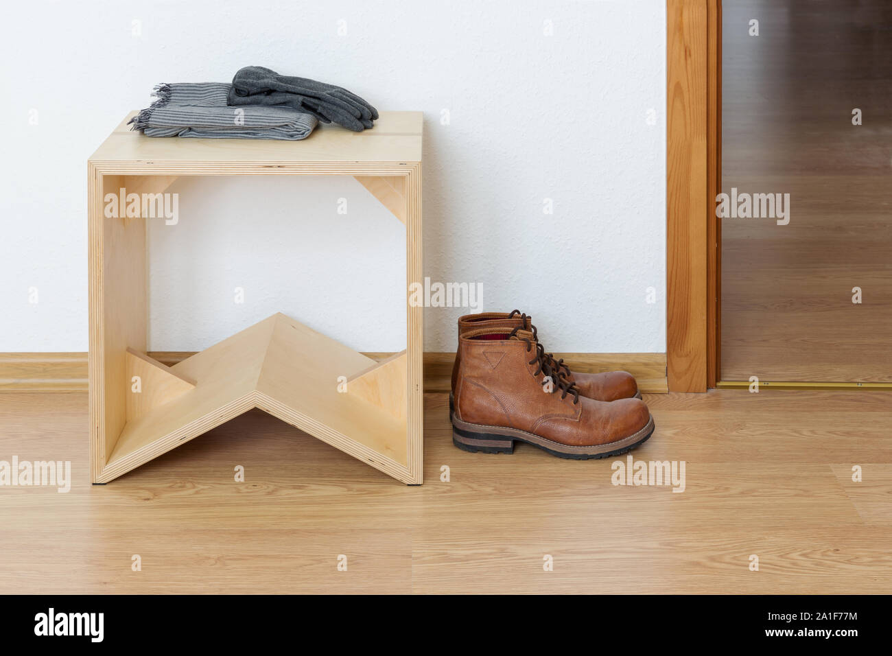 White empty anteroom with wooden stool and leather boots Stock Photo ...