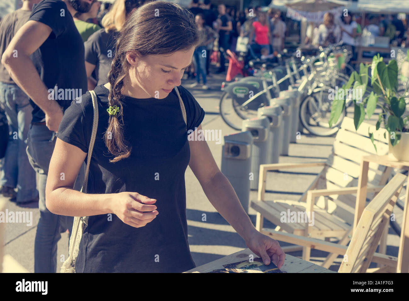 Female customer reading leaflet at outdoor market Stock Photo - Alamy