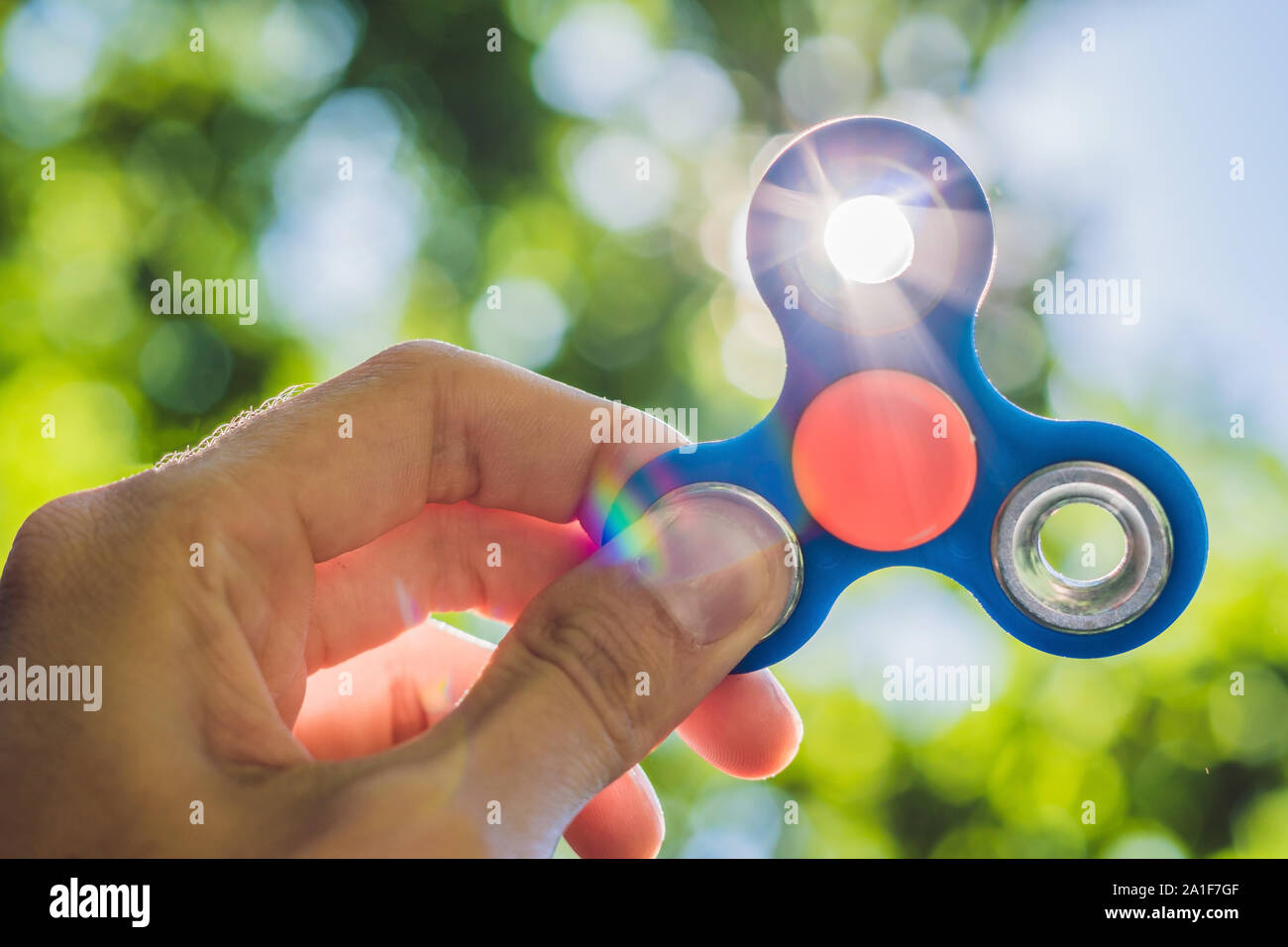Boy playing with fidget spinner. Child spinning spinner on the ...
