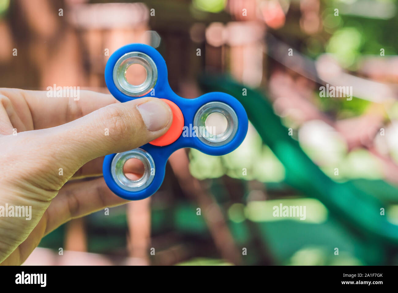 Boy playing with fidget spinner. Child spinning spinner on the ...