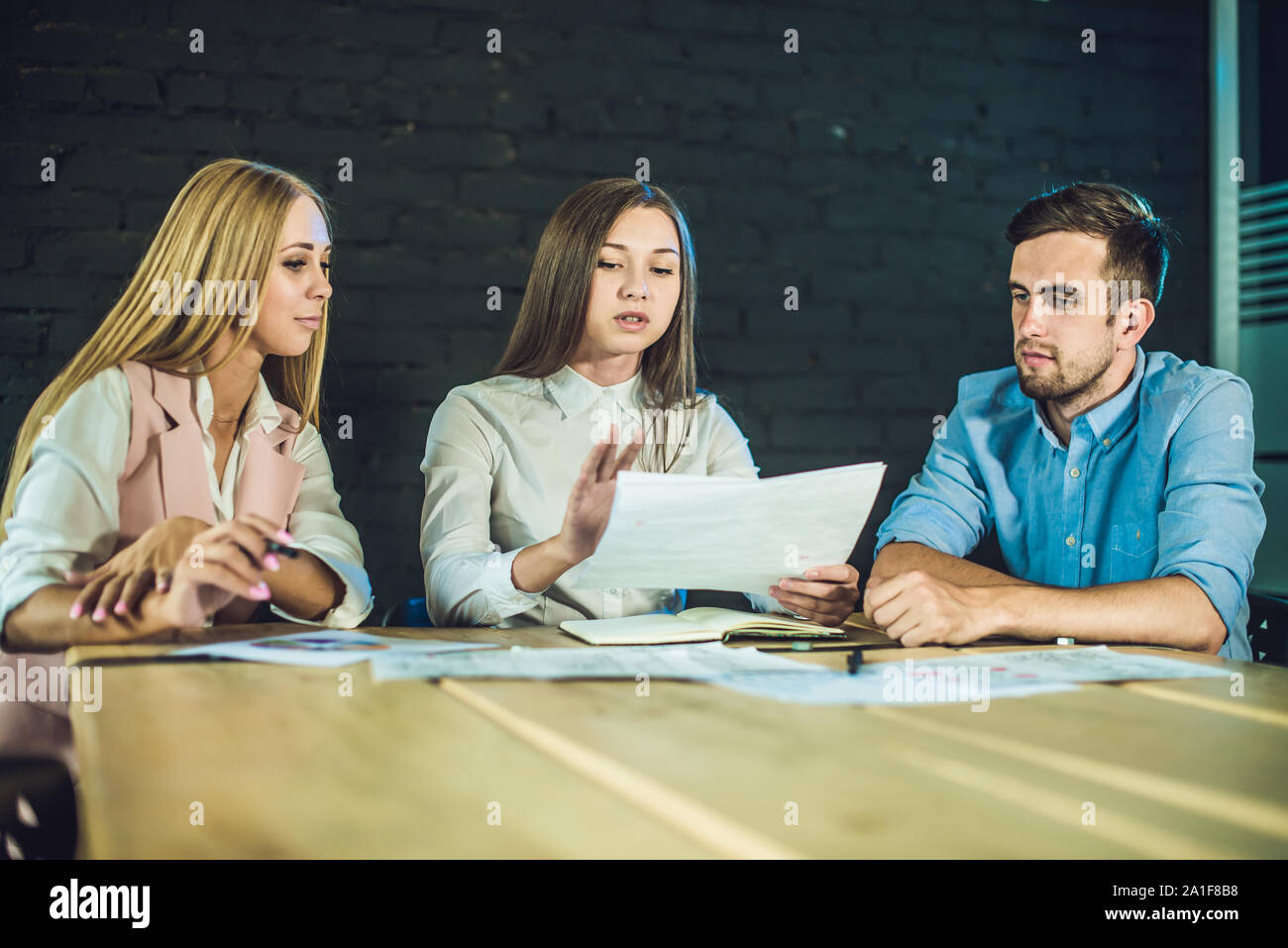 Young team of coworkers watching storyboard for shooting video in ...