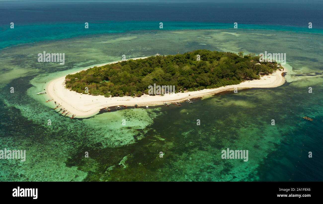 Tropical island in the blue sea with coral reef, top view. Small island ...