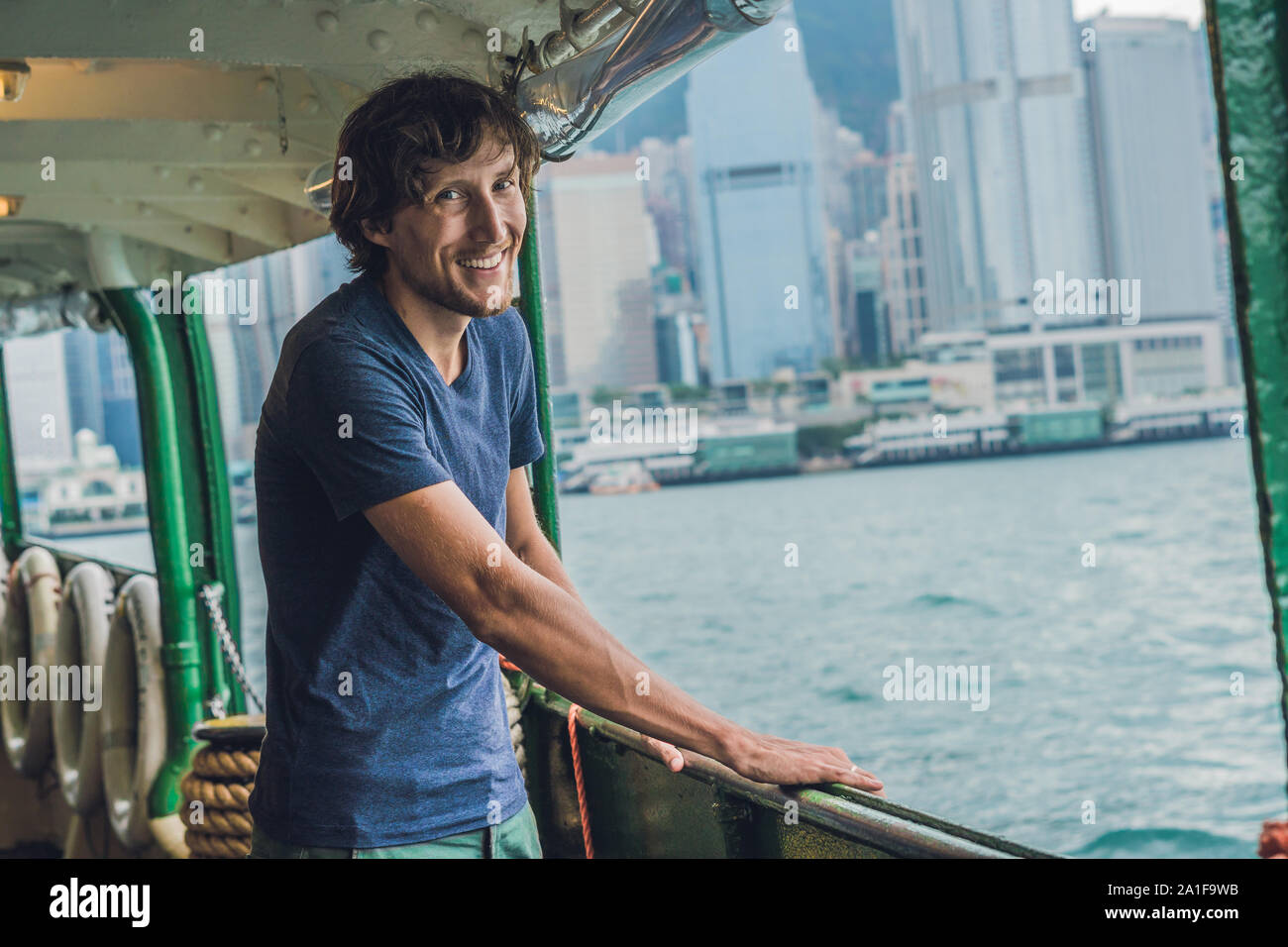 A young man on a ferry in Hong Kong Stock Photo - Alamy
