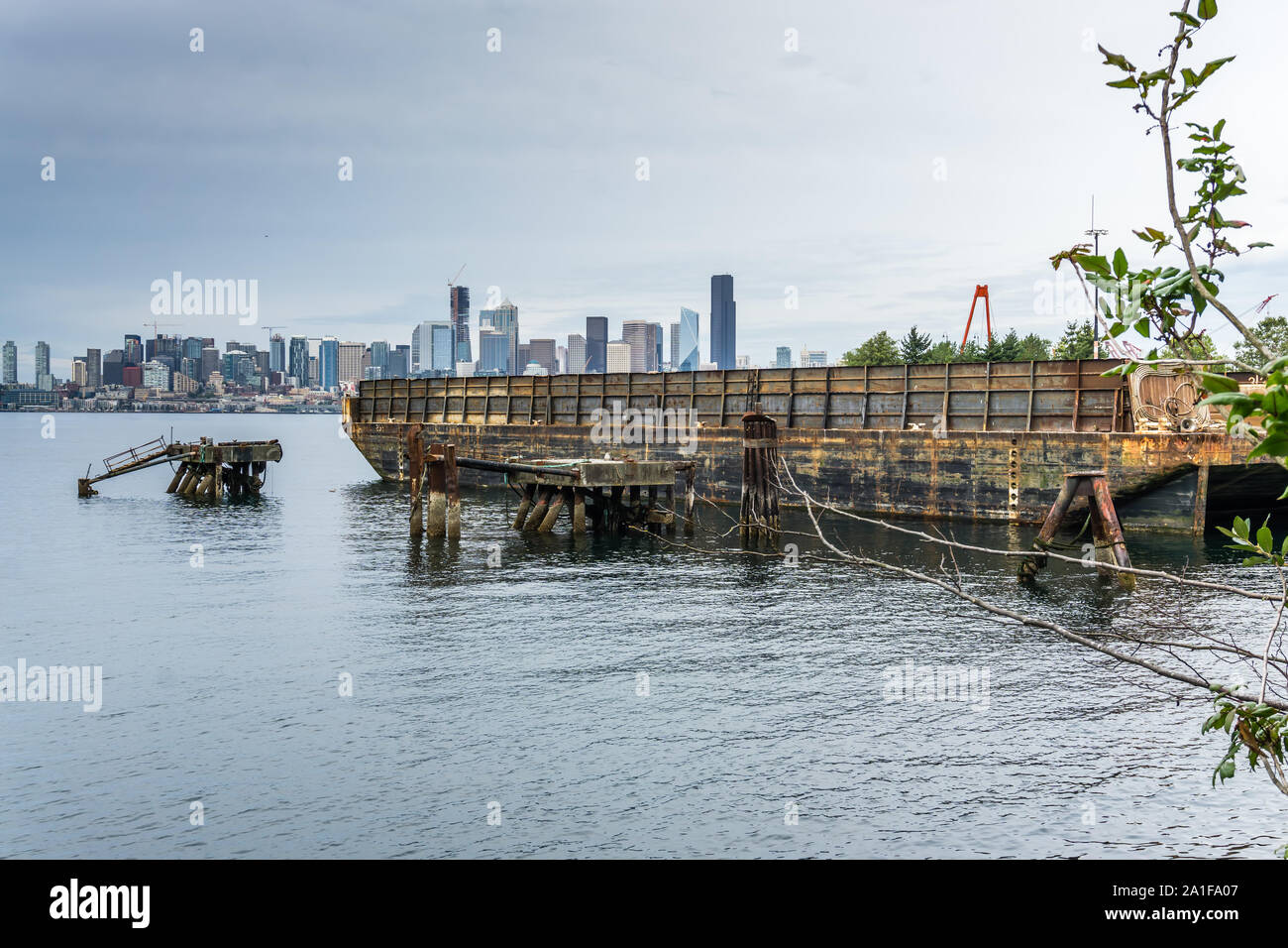A barge with the Seattle skyline in the distance Stock Photo - Alamy