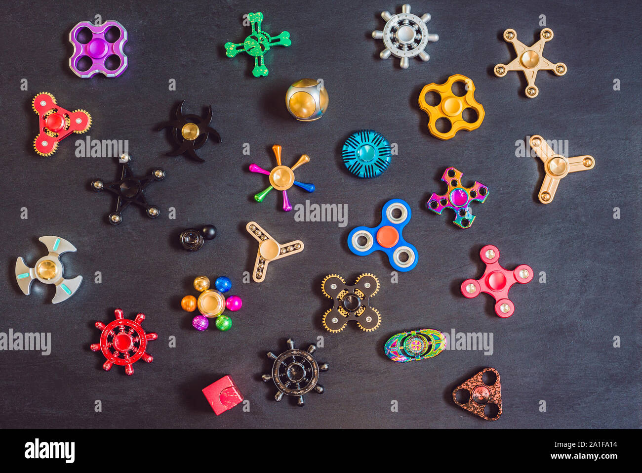 A lot of different spinners on a black background Stock Photo - Alamy