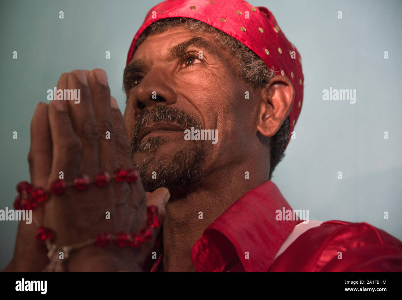 Afro-Brazilian man praying during carnival religious party Stock Photo ...