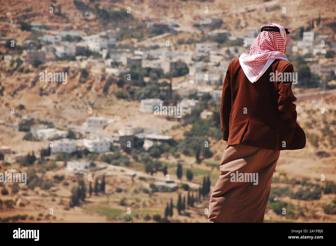 Jordanian man wearing arab traditional clothes in the top of the hill ...