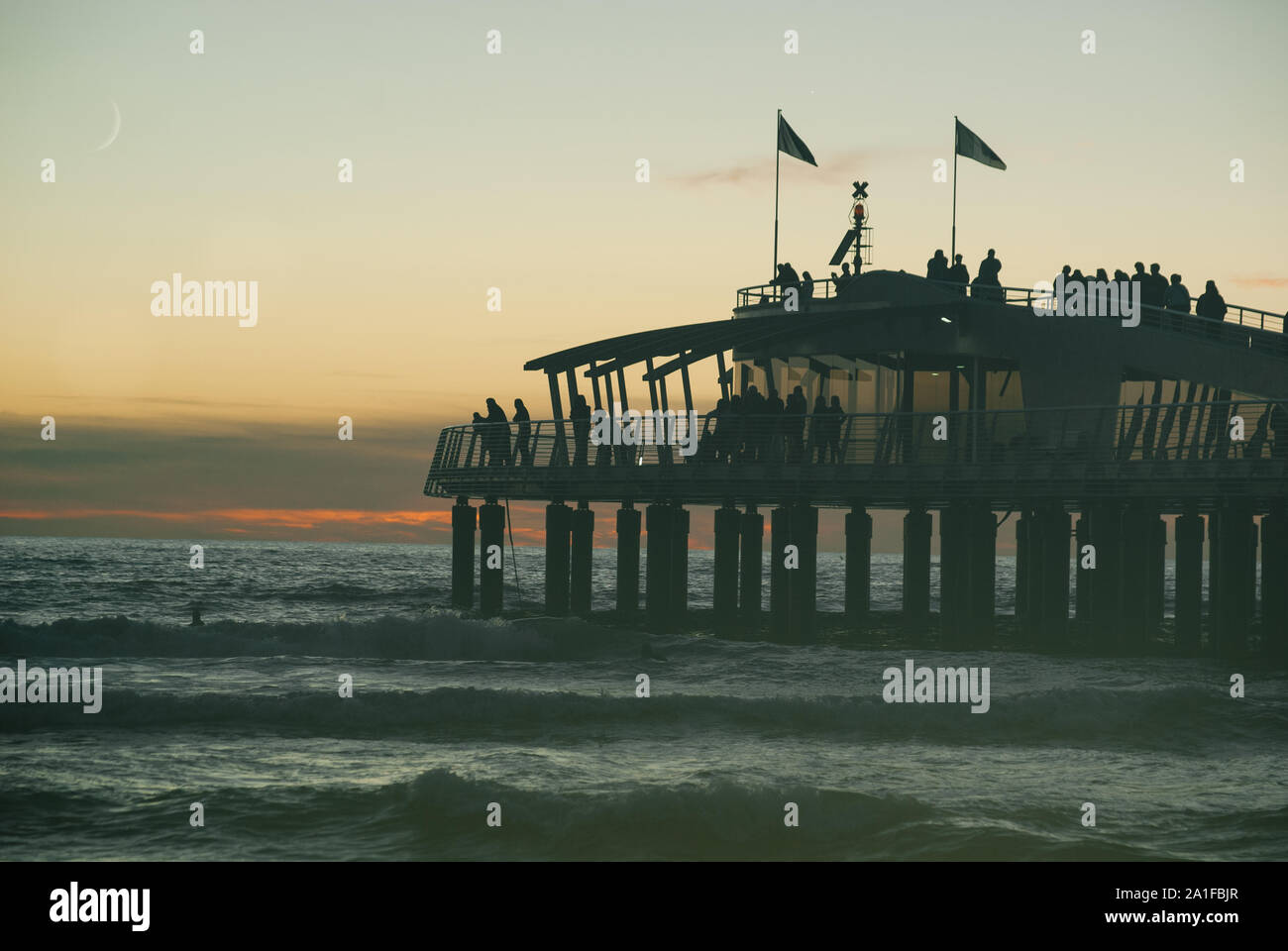 People watch the sunset from a pier, unrecognizable faces Stock Photo ...