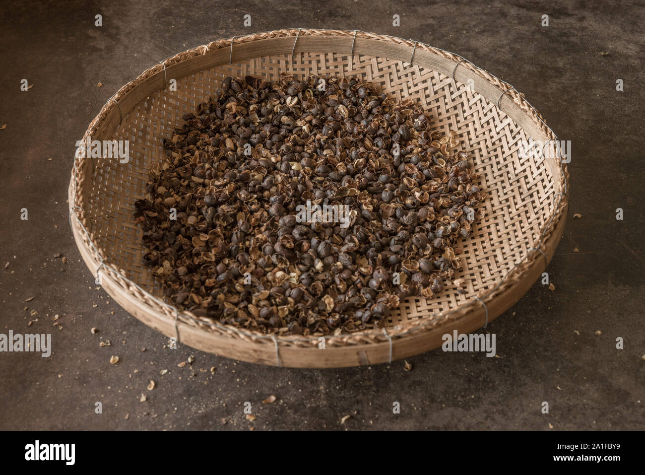 Skins of toasted coffee beans inside bamboo sieve Stock Photo - Alamy