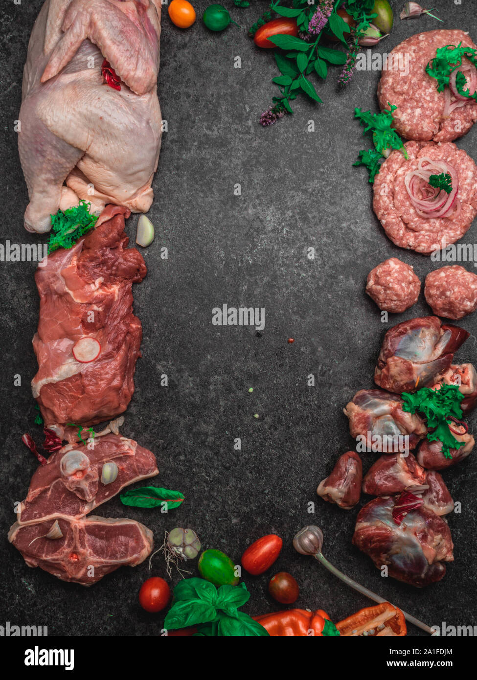 Assorted raw meat on dark background. Different types of meat and ...
