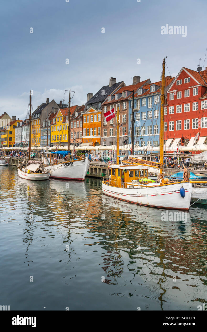 Colorful townhouses along a canal in the Nyhavn district of Copenhagen ...