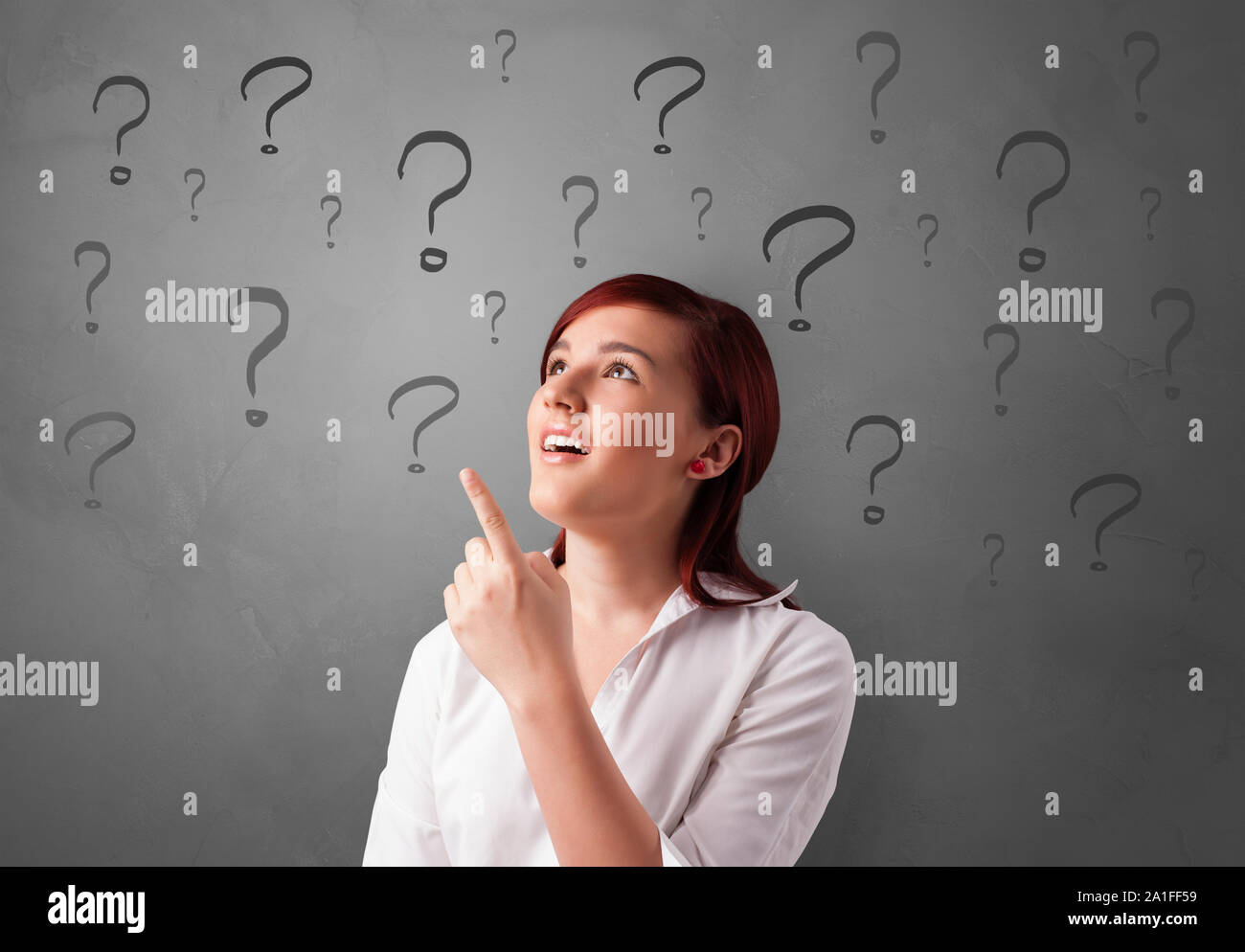 Person with question marks around face Stock Photo - Alamy