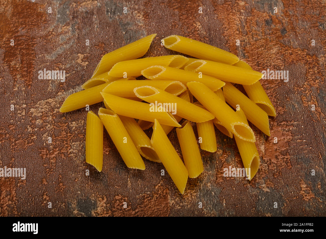 Raw penne pasta ready for bowl Stock Photo - Alamy