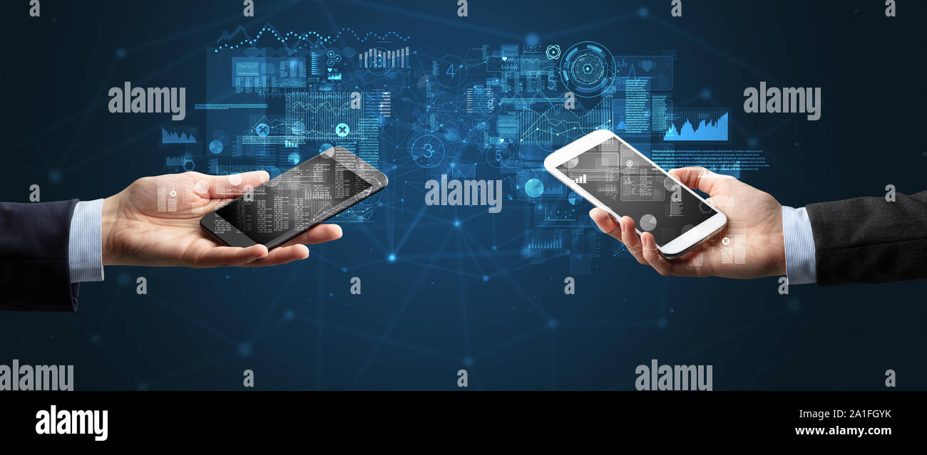 Close up of two hands holding smartphones to sync business data Stock ...