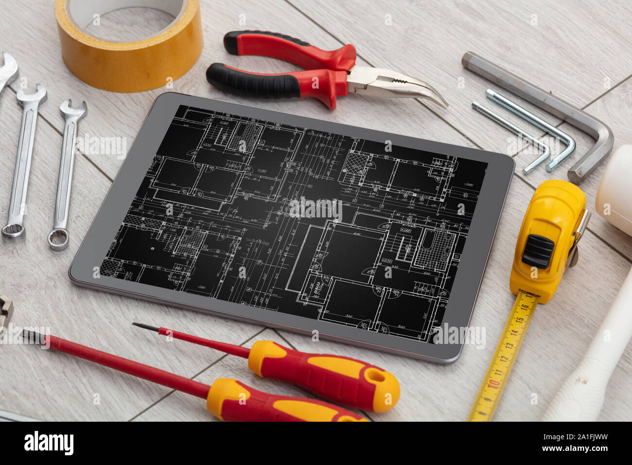 Tablet with construction tools and blueprint concept Stock Photo - Alamy