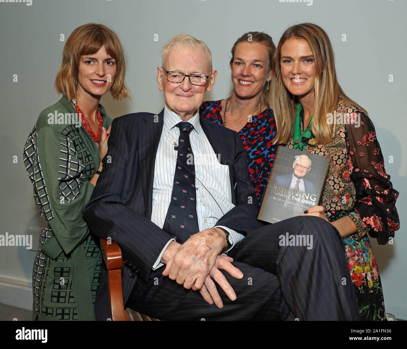 Stuart Wheeler, holding his book, and his three daughters, model ...