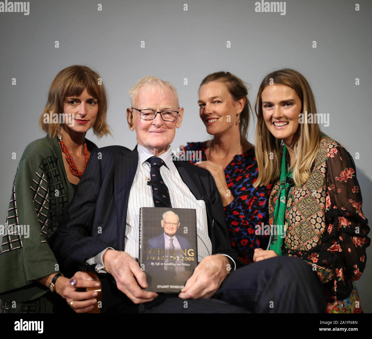 Stuart Wheeler, holding his book, and his three daughters, model ...