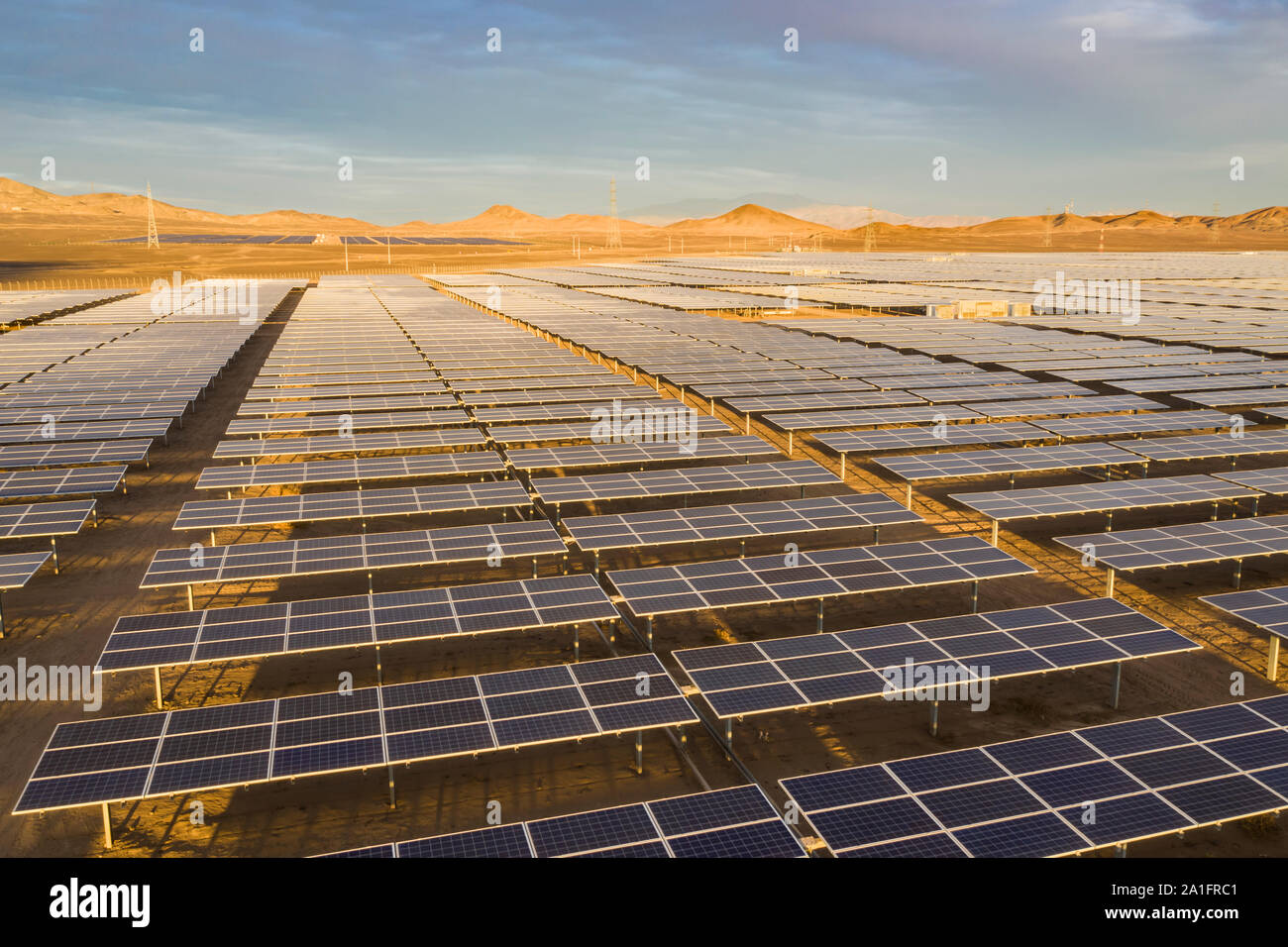 Aerial view of hundreds solar energy panels rows along the dry lands at Atacama Desert, Chile ...