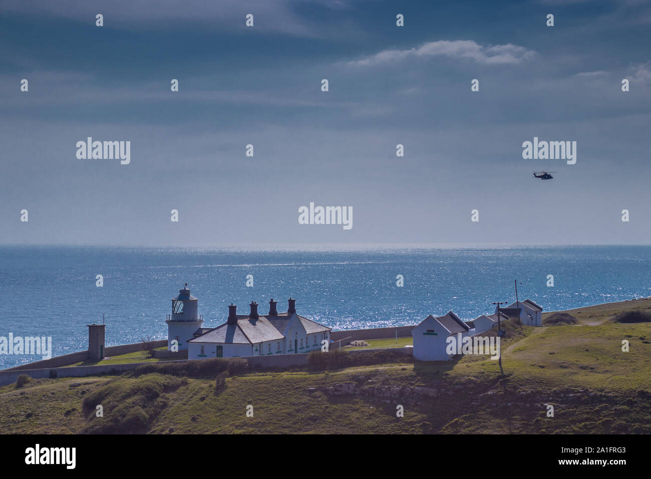 Coastguard helicopter over Anvil Point lighthouse in Durlston Country ...