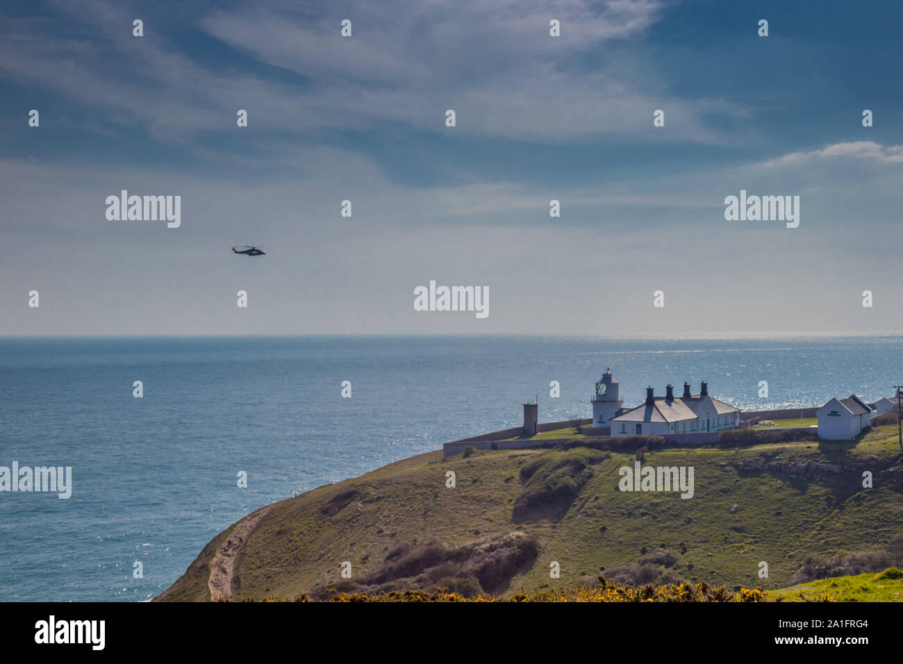 Coastguard helicopter over Anvil Point lighthouse in Durlston Country ...