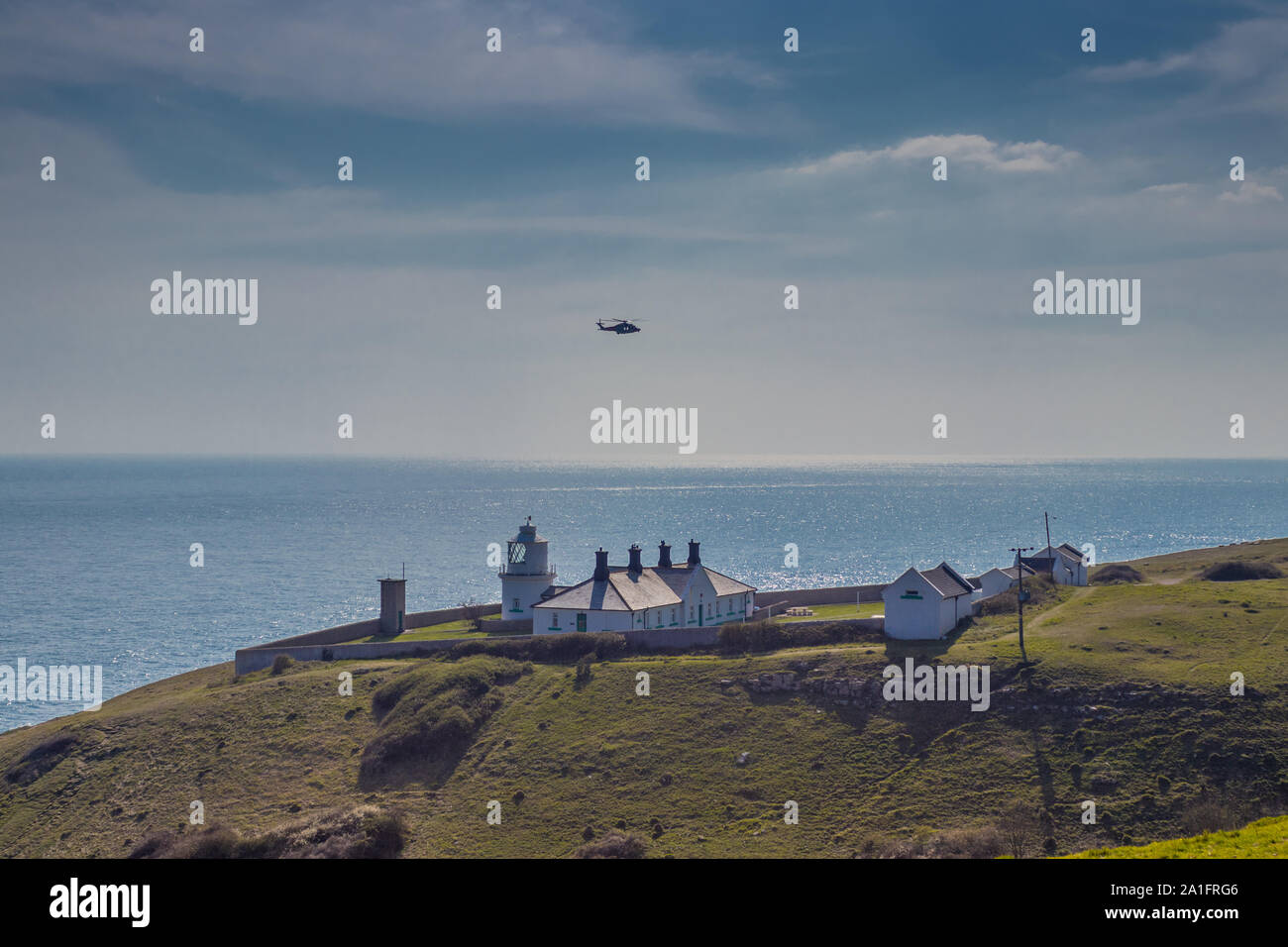 Coastguard helicopter over Anvil Point lighthouse in Durlston Country ...