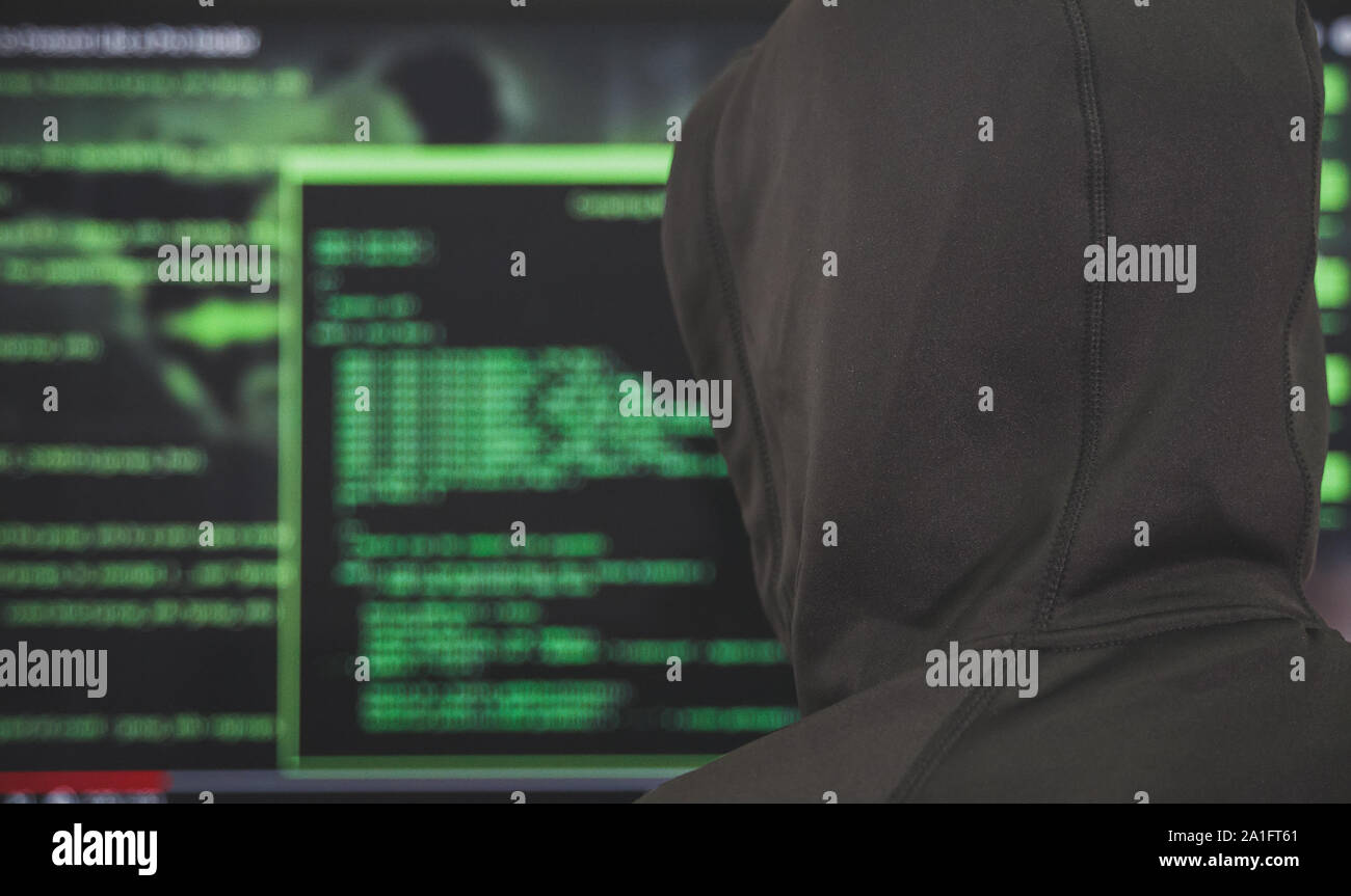 Hacker in black hoodie. Hacking and internet security concept Stock Photo - Alamy