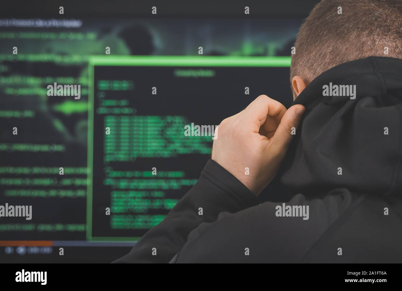 Hacker in black hoodie. Hacking and internet security concept Stock Photo - Alamy