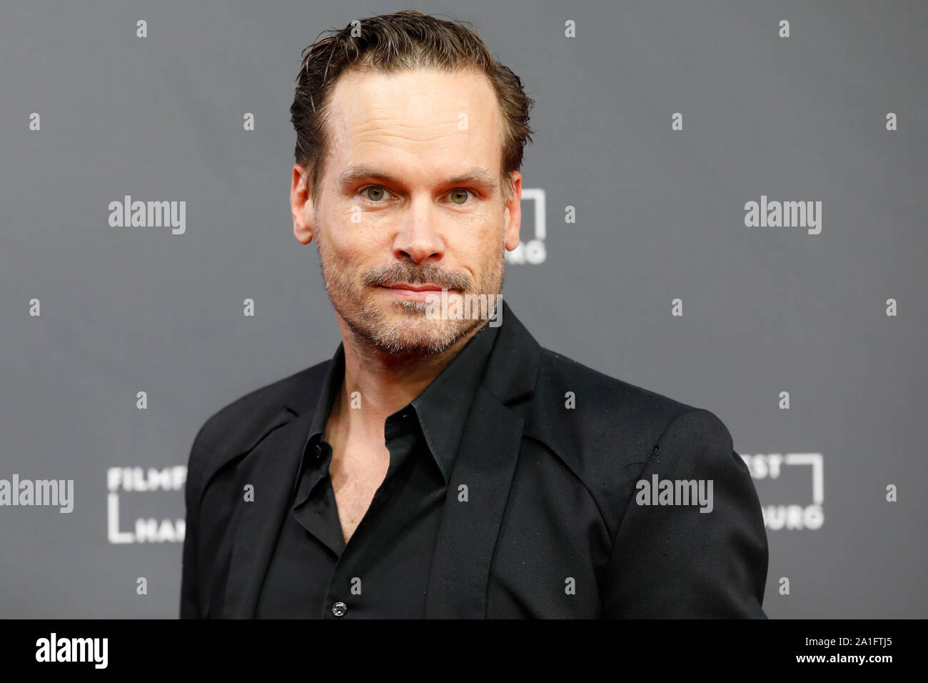 Hamburg, Germany. 26th Sep, 2019. Actor Wanja Mues crosses the red ...