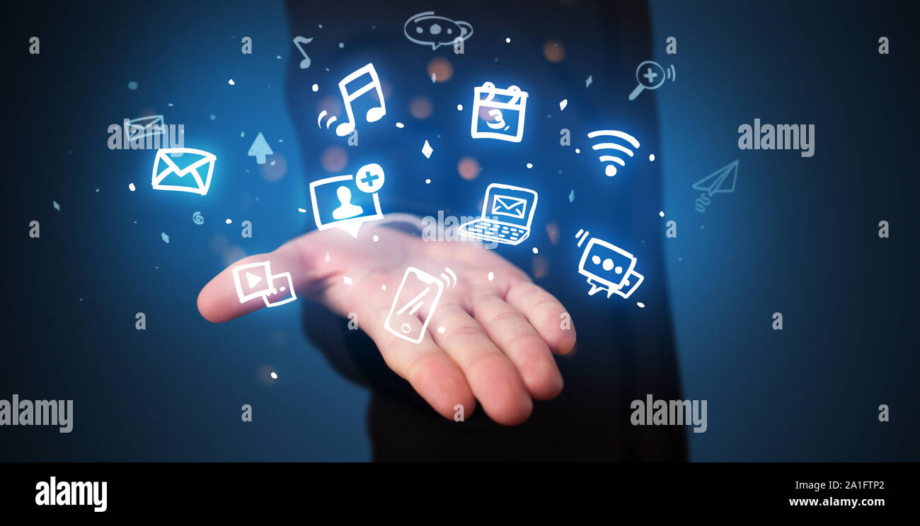 Hand holding application icons and symbols in her hand Stock Photo - Alamy