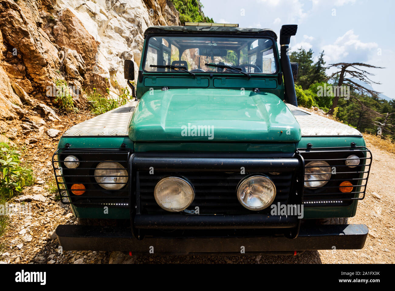 Four wheel drive vehicle 4x4 with all terrain tires parked in mountains ...