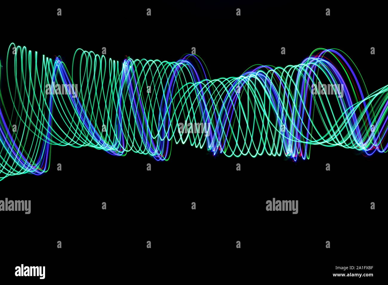 Long exposure photograph of neon green and blue colour in an abstract ...
