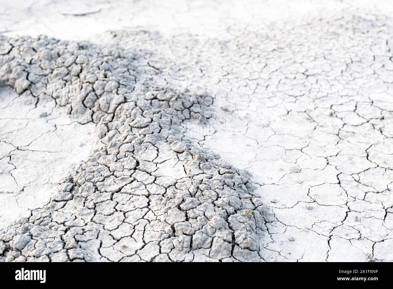 Dried ground with cracks. Grey land us a symbol ecological catastrophe ...