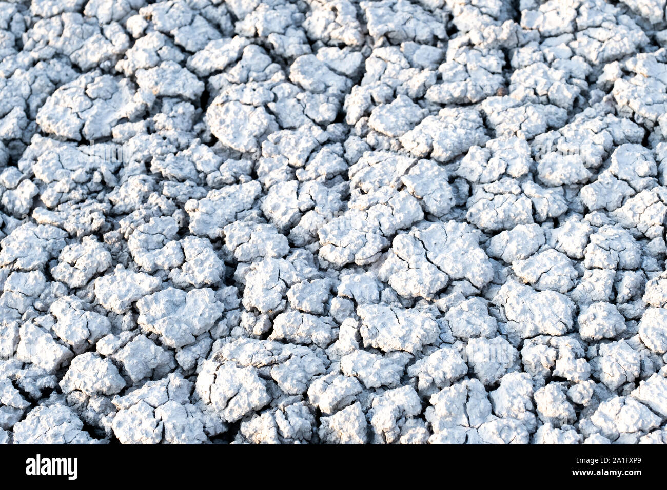 Dried ground with cracks. Grey land us a symbol ecological catastrophe ...