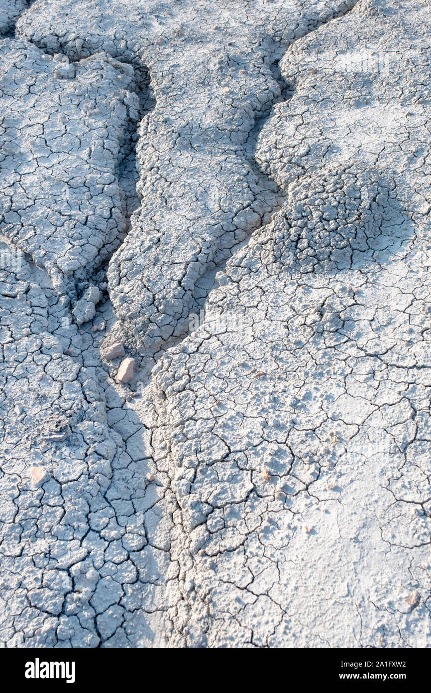 Dried ground with cracks. Grey land us a symbol ecological catastrophe ...