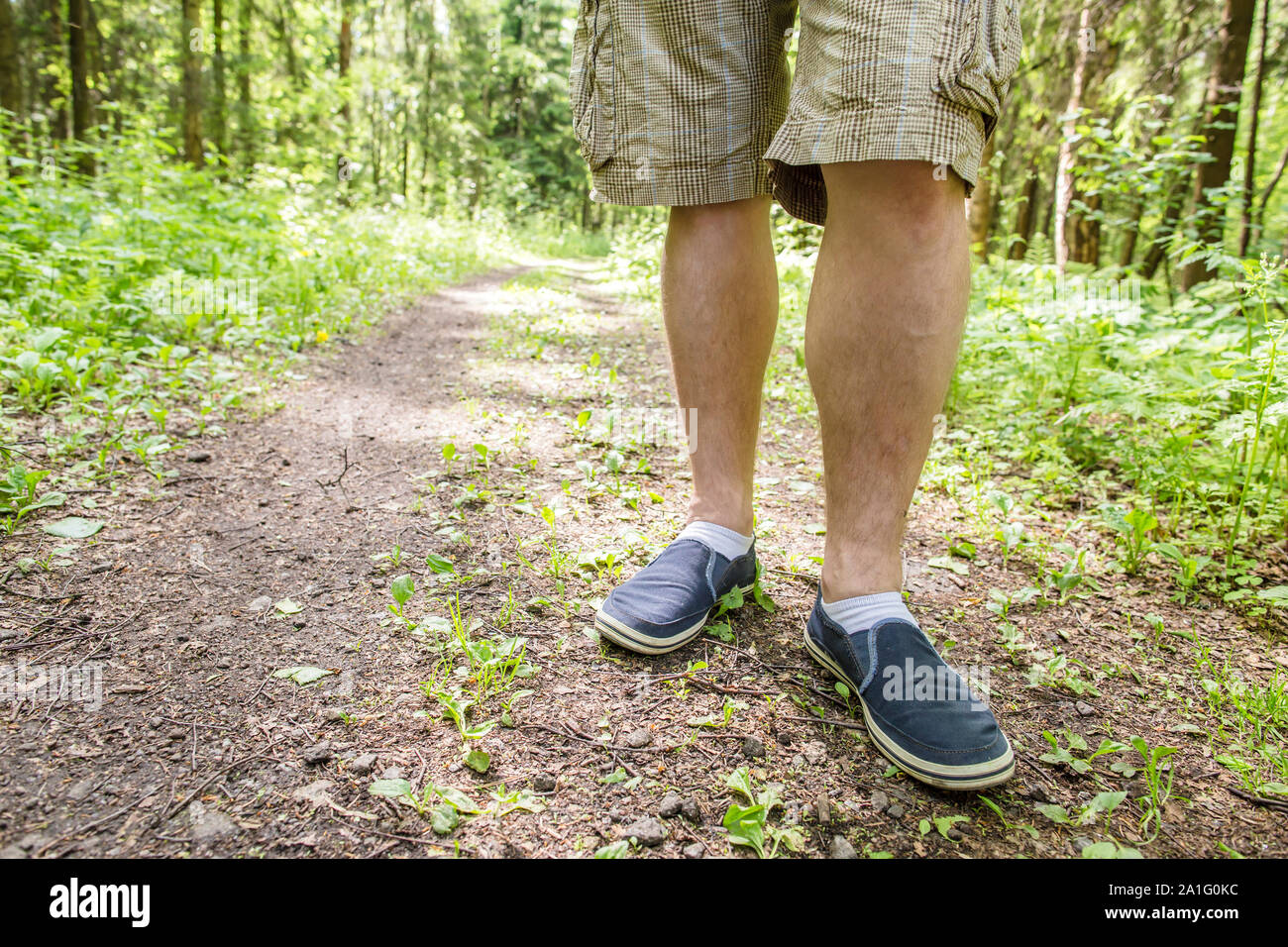 a man standing on the footpath after a long walk in the background ...