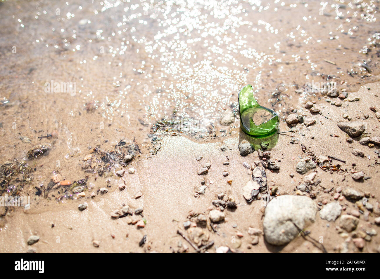 Broken bottle of sharp edged lying on the riverbank Stock Photo - Alamy