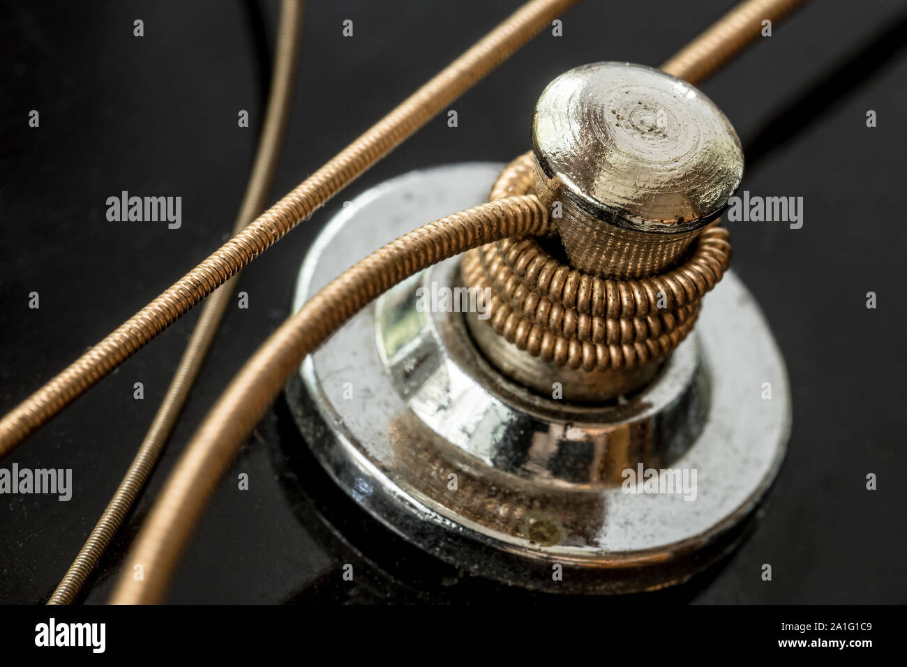 thick string close-up, wound on a peg black lacquered Acoustic Guitar ...