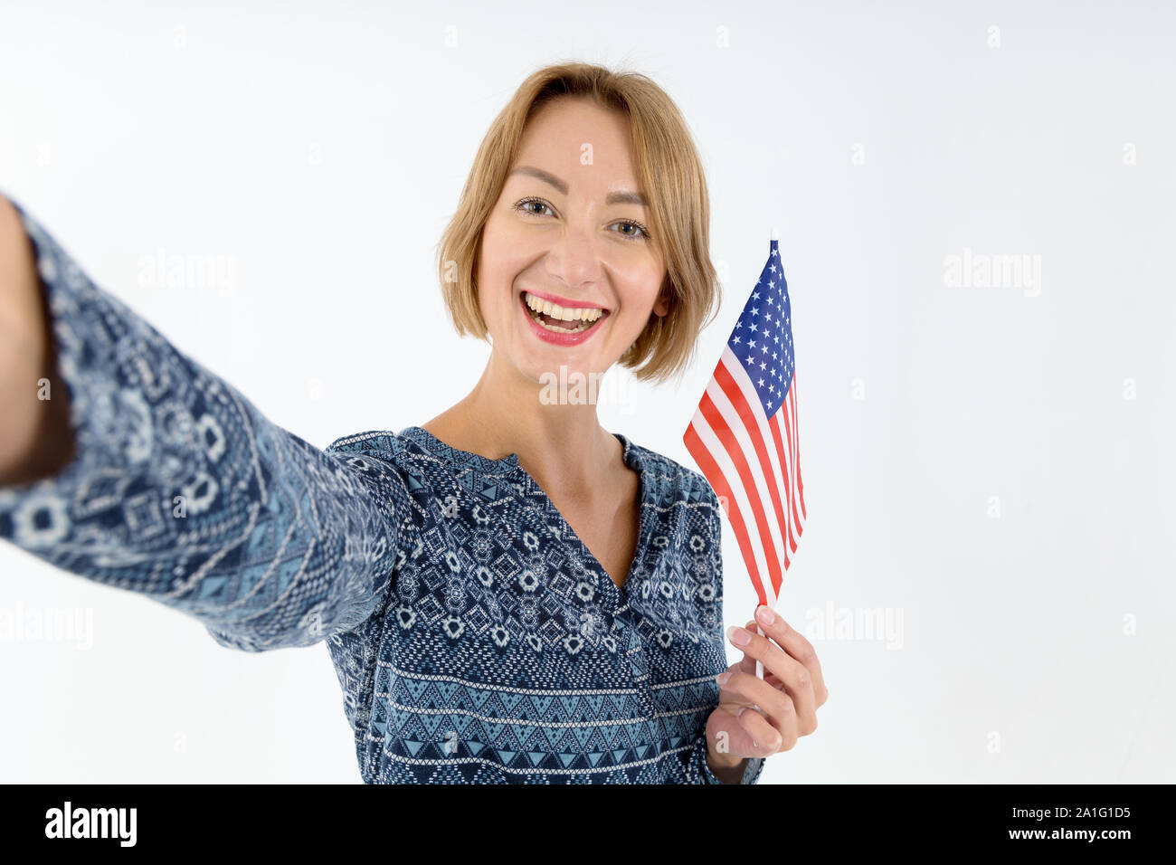 Selfie portrait of a beautiful woman with the flag of the United States ...