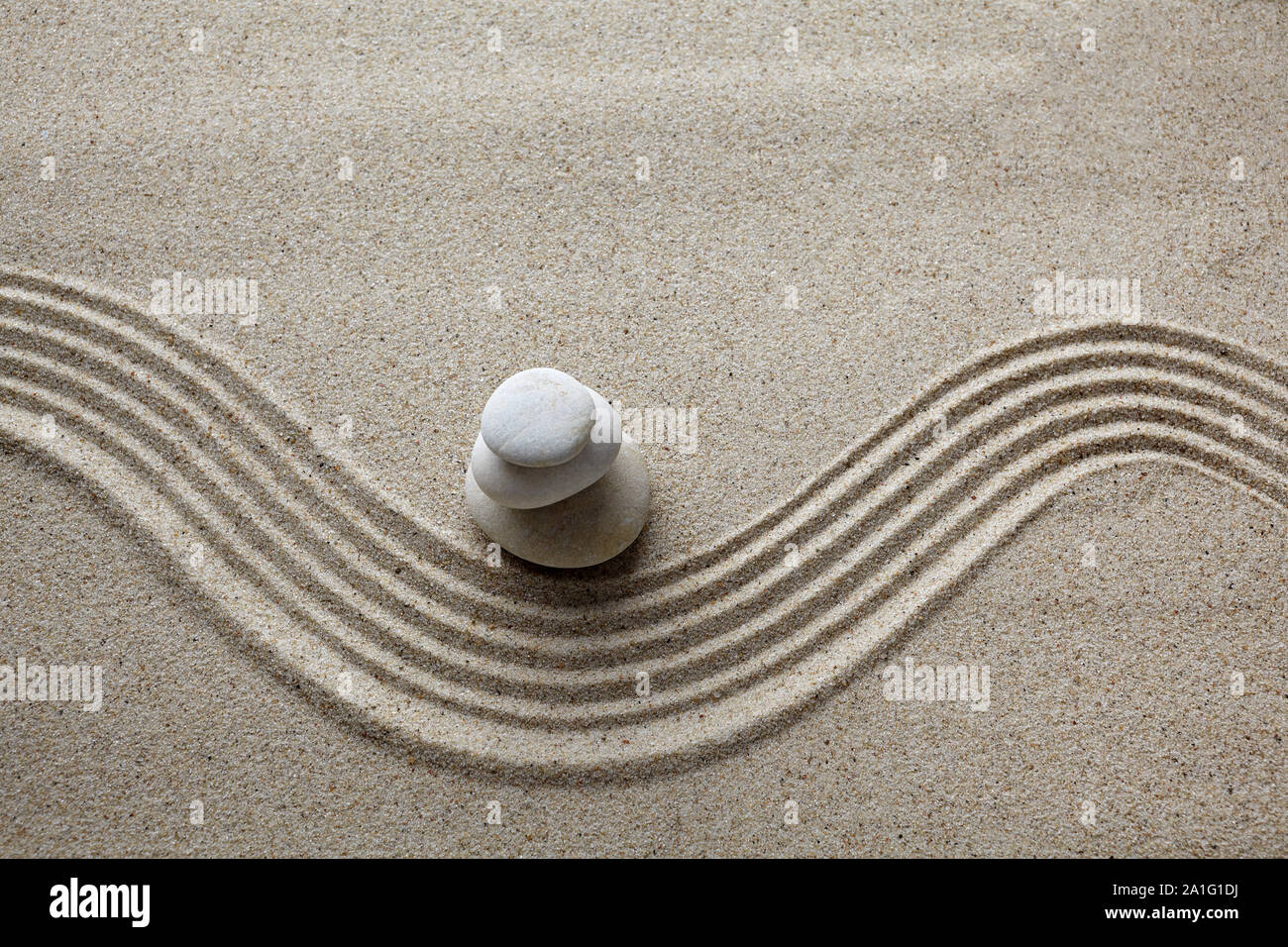 Zen garden, stone on sand. Top view Stock Photo - Alamy