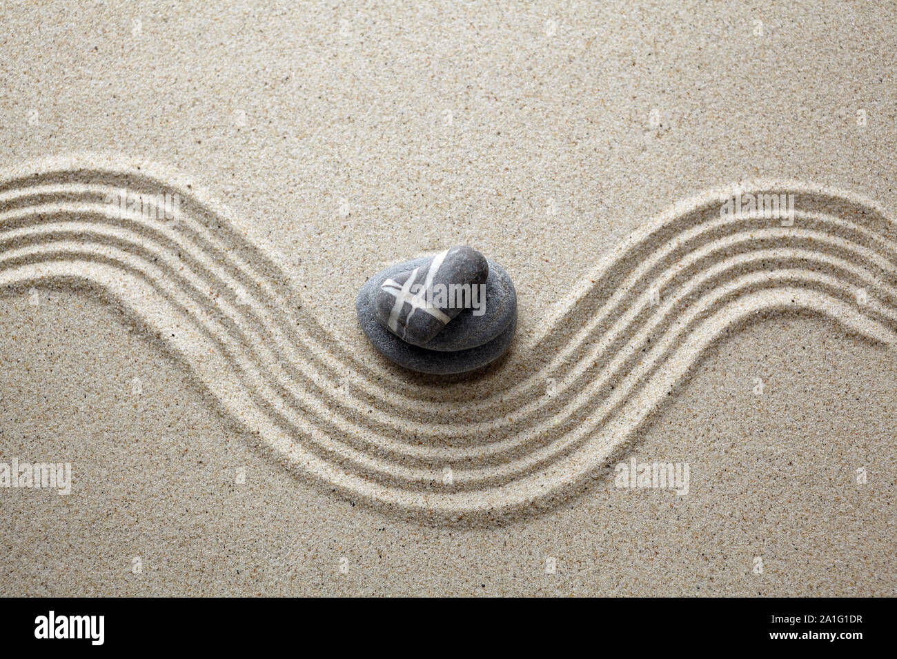 Zen garden, stone on sand. Top view Stock Photo - Alamy