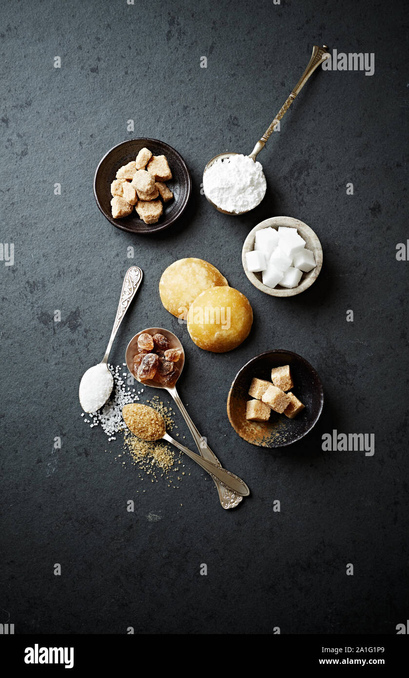 Assorted types of sugar on a stone background Stock Photo - Alamy