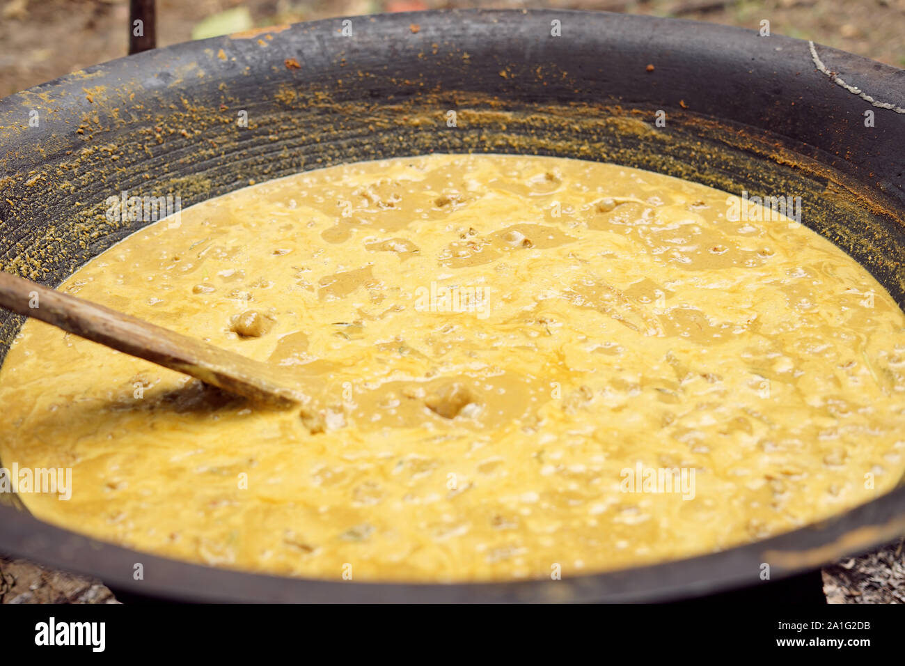 Cooking traditional spicy curry in huge pan Stock Photo - Alamy