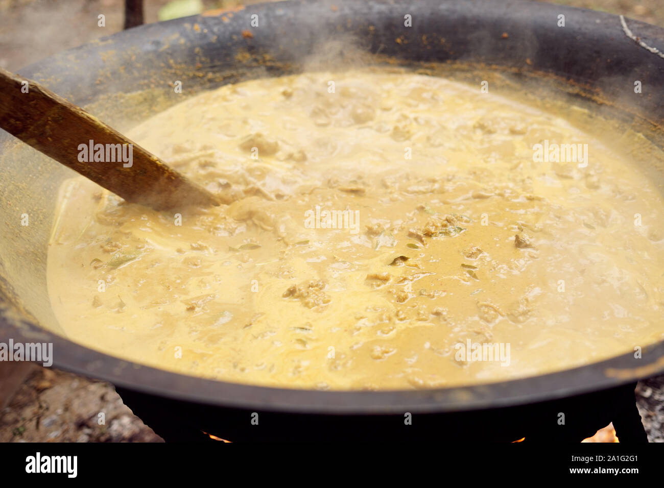 Cooking traditional spicy curry in huge pan Stock Photo - Alamy