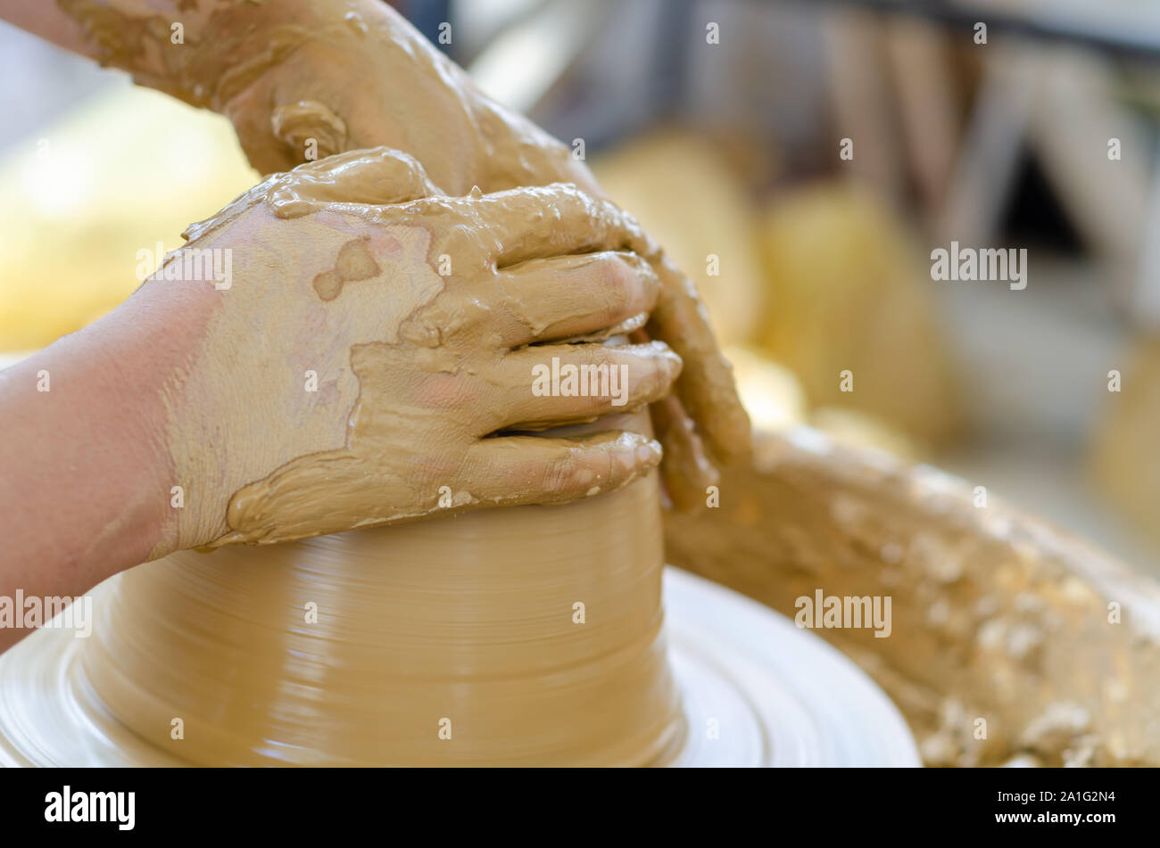 Ceramic working process with clay potter's wheel, close up. The man is ...