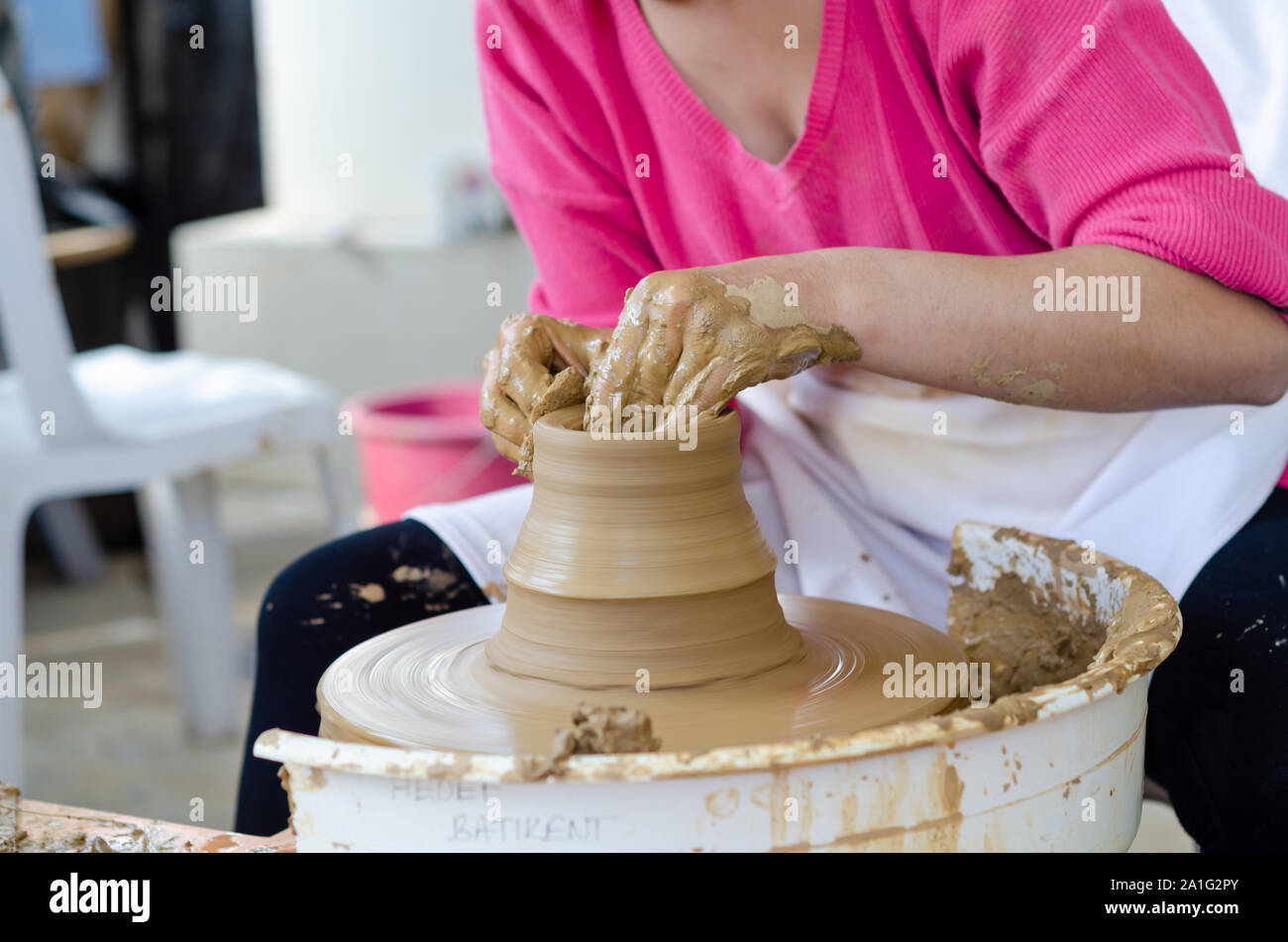 Ceramic working process with clay potter's wheel, close up. The woman ...