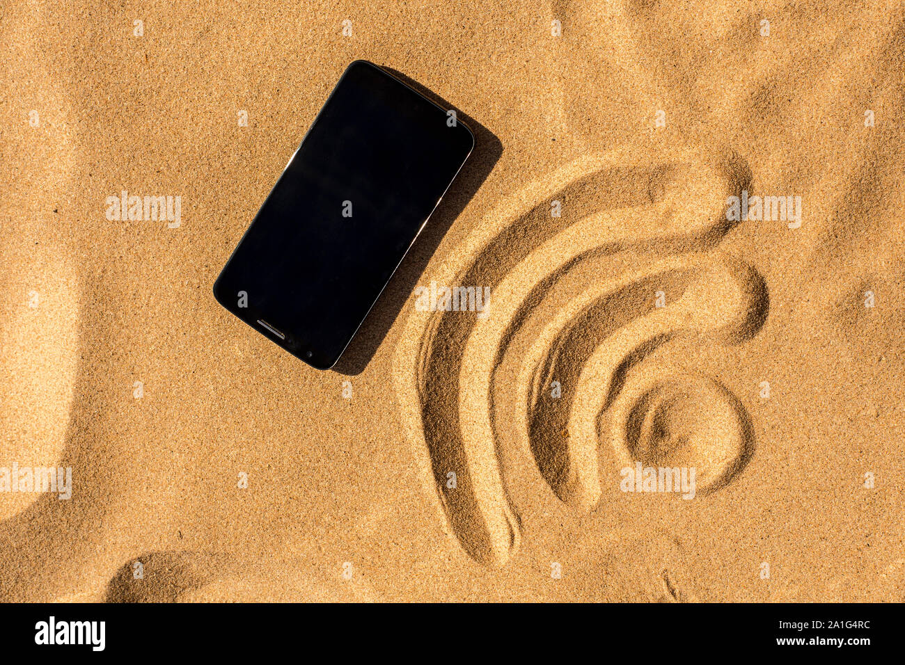 mobile phone lying on the beach, in the sand, which drafted the WiFi ...