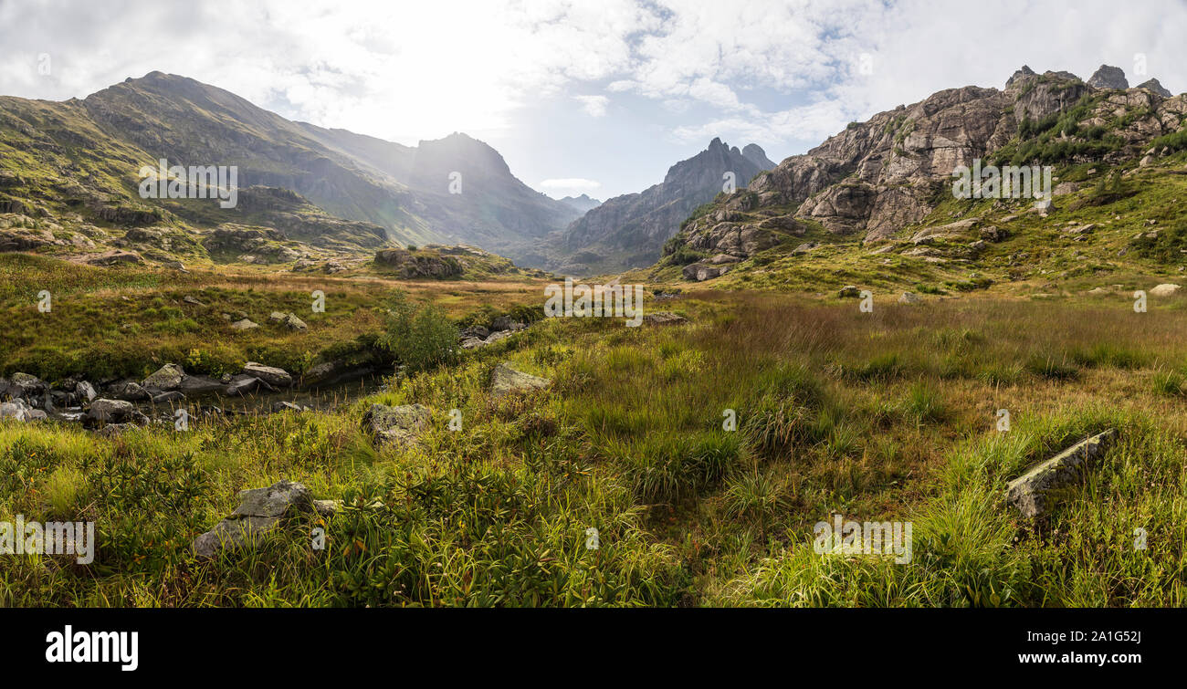 panorama of mountain scenery with meadow, located in a river valley in ...