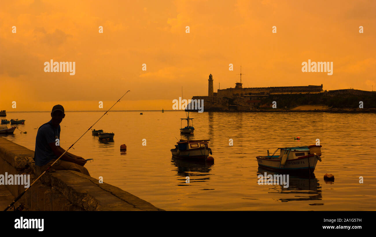 A Cuban fishing off the Malecon of Havana. In the Bay of Havana, in the ...