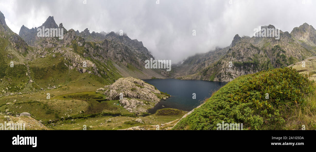 panorama landscape with a lake in the mountains, huge rocks and stones ...