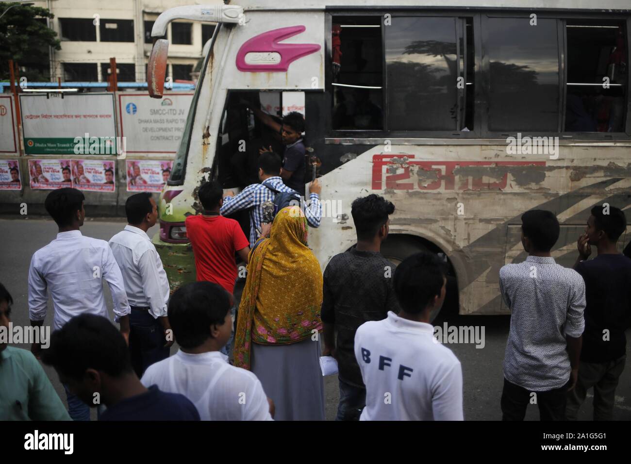 Dhaka, Bangladesh. 27th Sep, 2019. A man tries to get into a bus as ...